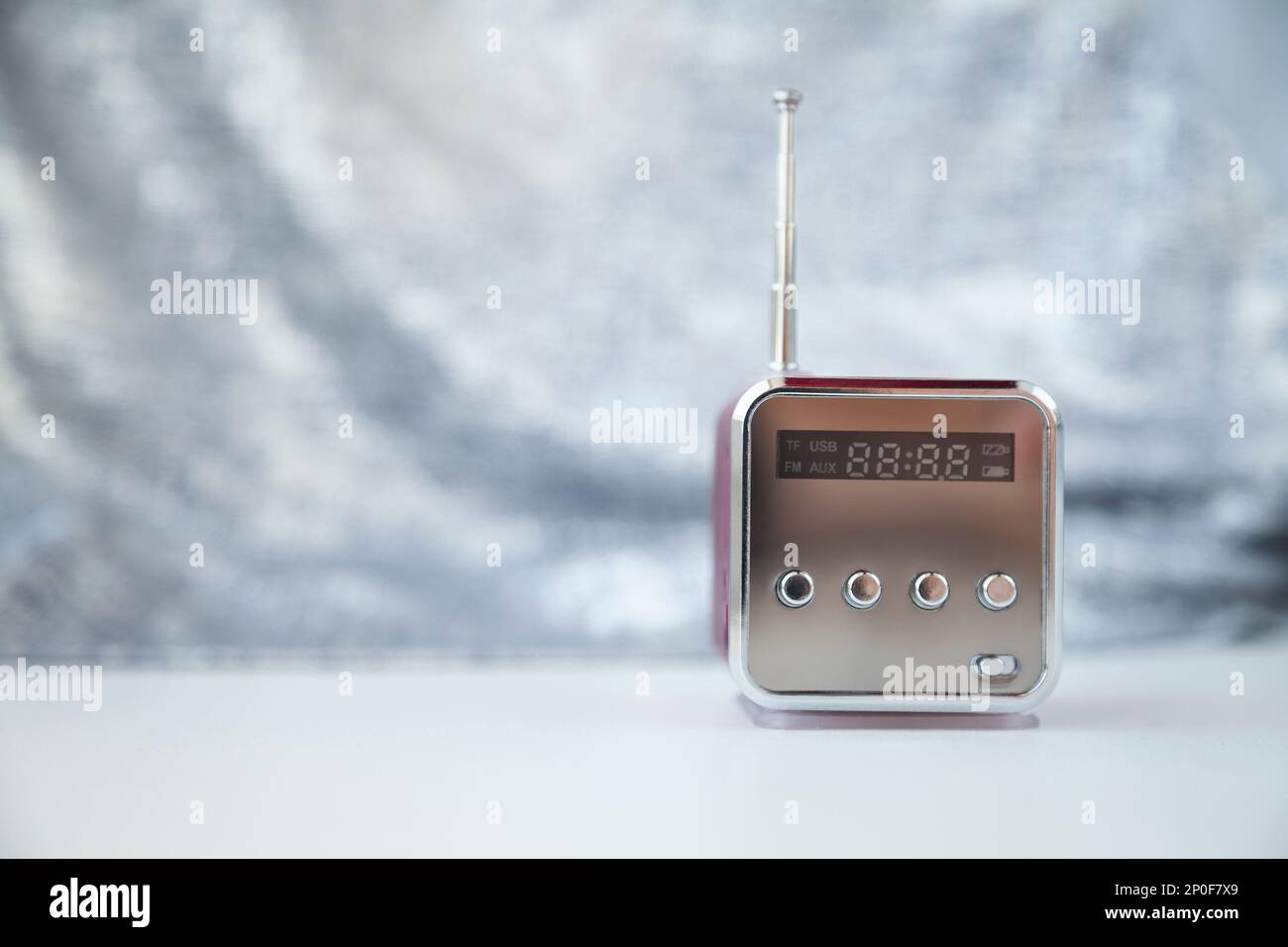 Cute little modern radio with antenna on a gray background. New ...