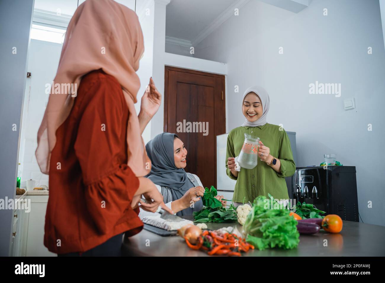 muslim woman cooking for dinner at friends home during ramadan Stock ...