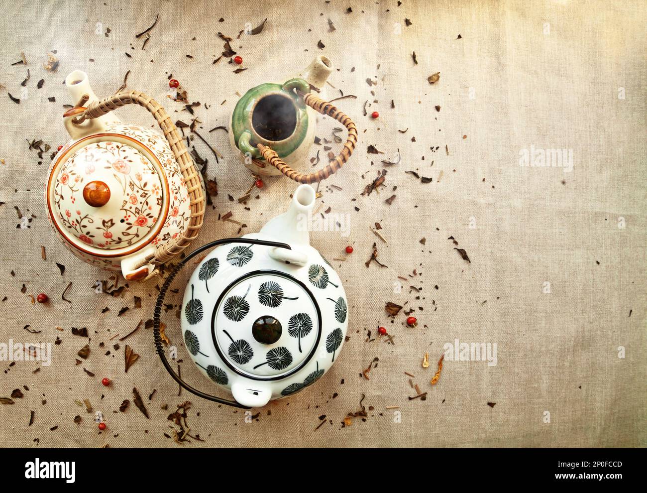 3 various traditional ceramic teapots on a canvas background with copy ...