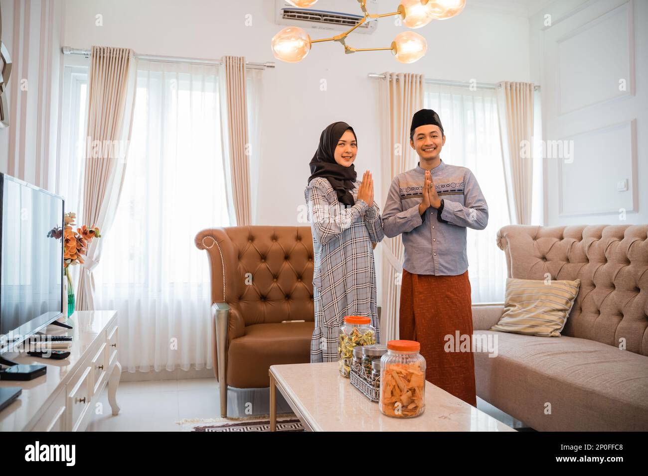 Asian Muslim couple wishing a happy Eid Stock Photo - Alamy