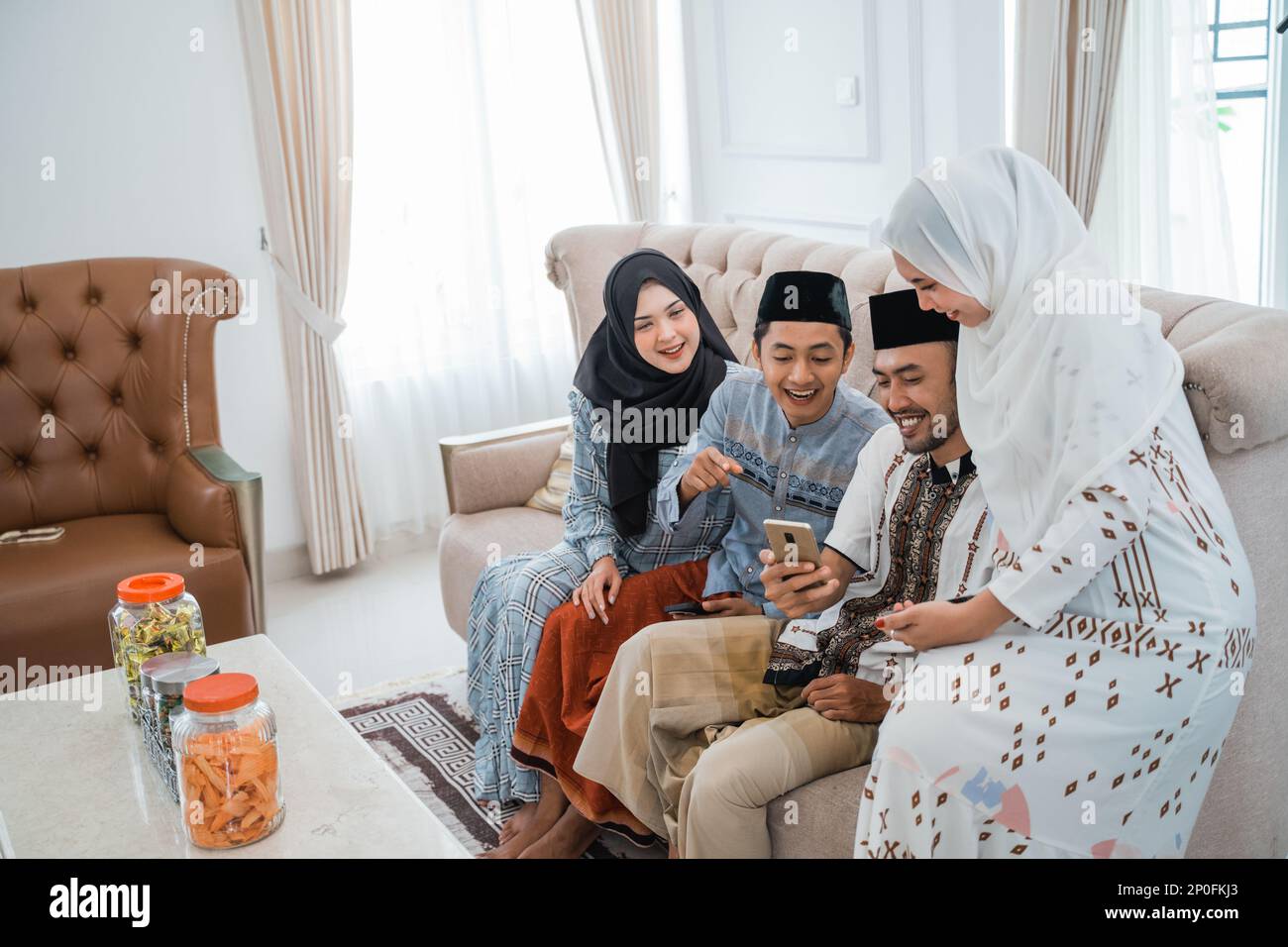 Muslim family together on sofa hi-res stock photography and images - Alamy