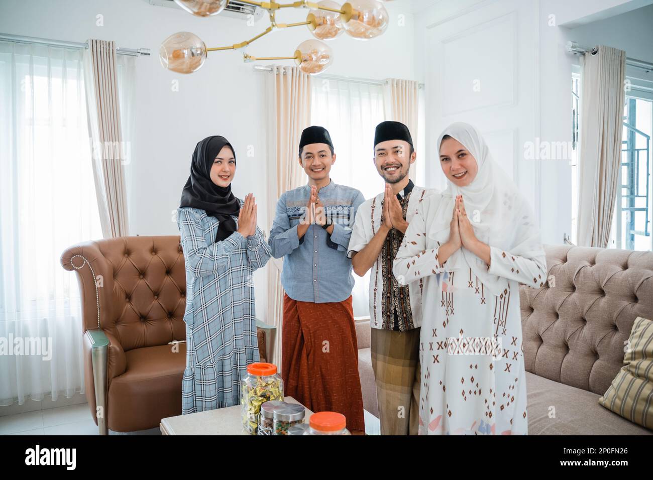 group of muslim people with apologizing hand gestures during Eid Stock ...