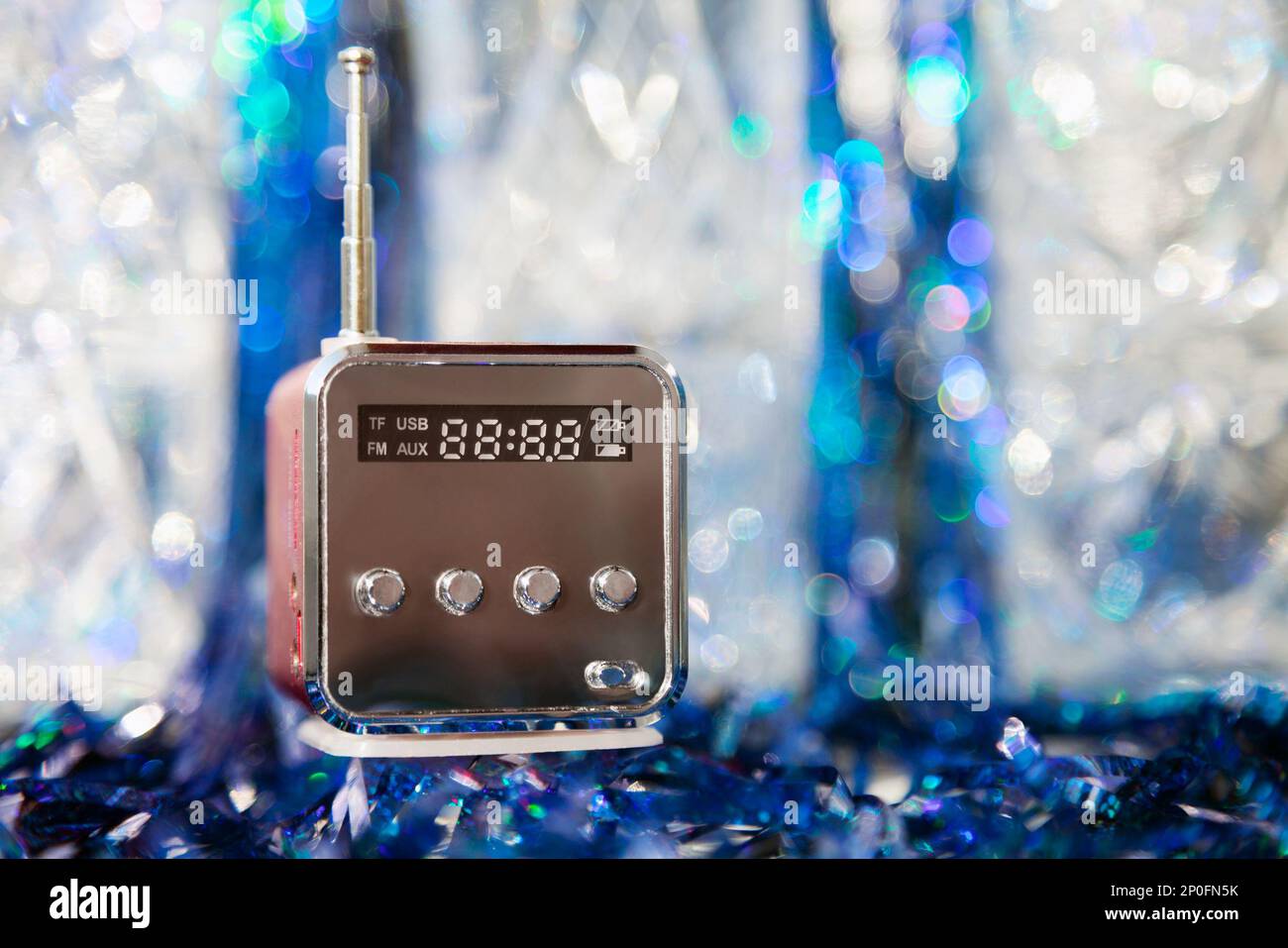 Cute little modern radio with antenna on a blue sparkling background ...