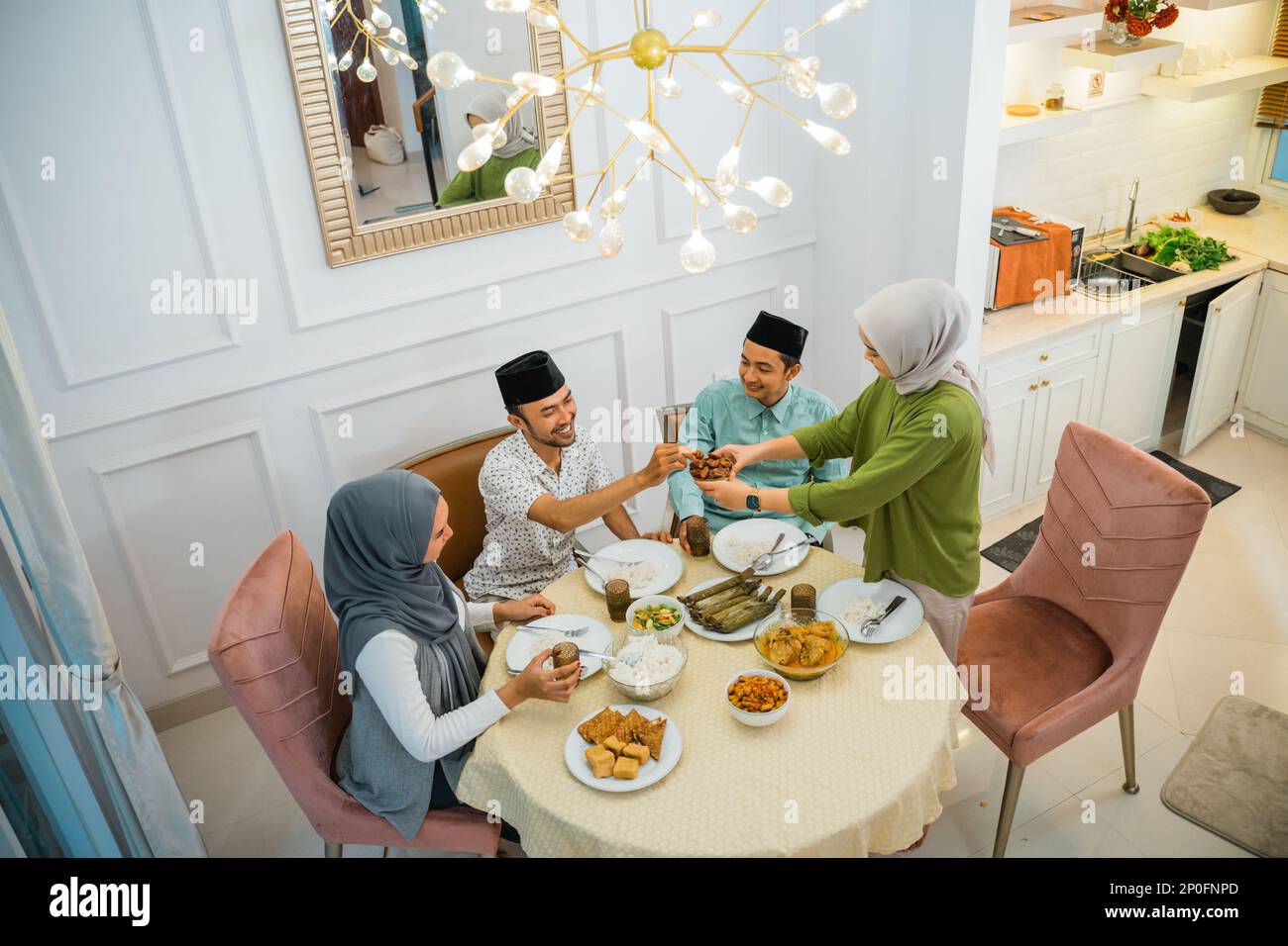 wife serves dates when breaking fast with friends at home Stock Photo ...