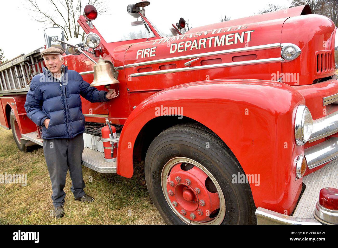 John Holton stands next to a 1956 Seagrave fire engine, one of three ...