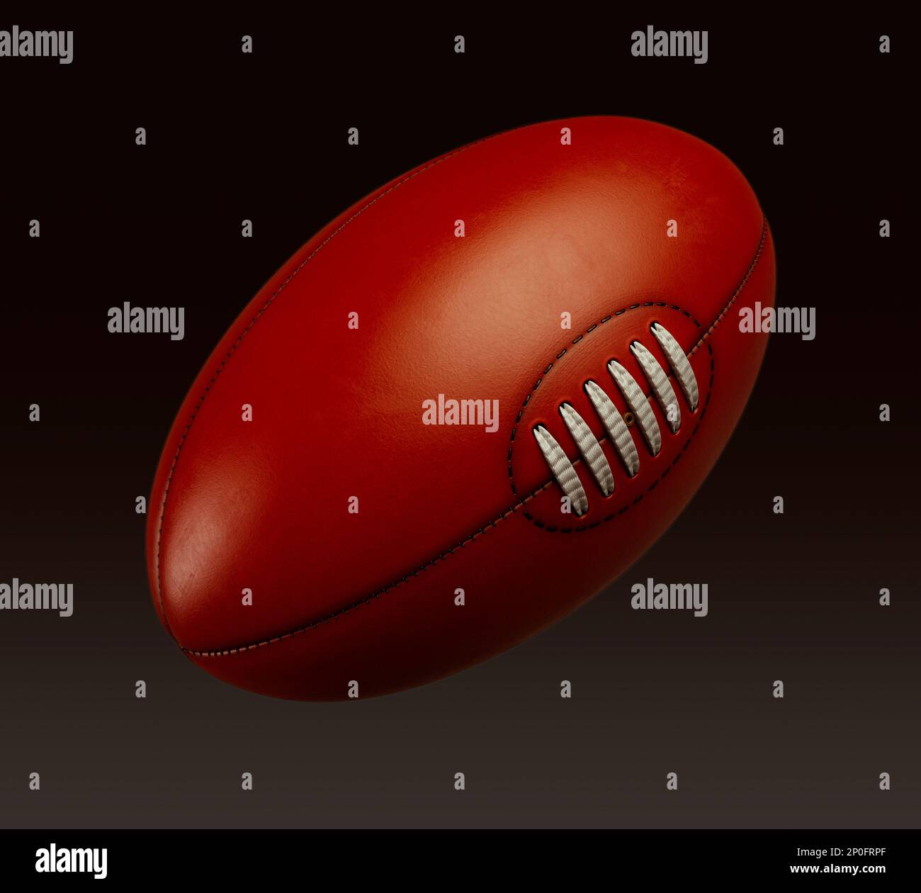 A generic unbranded aussie rules football ball on an isolated dark ...