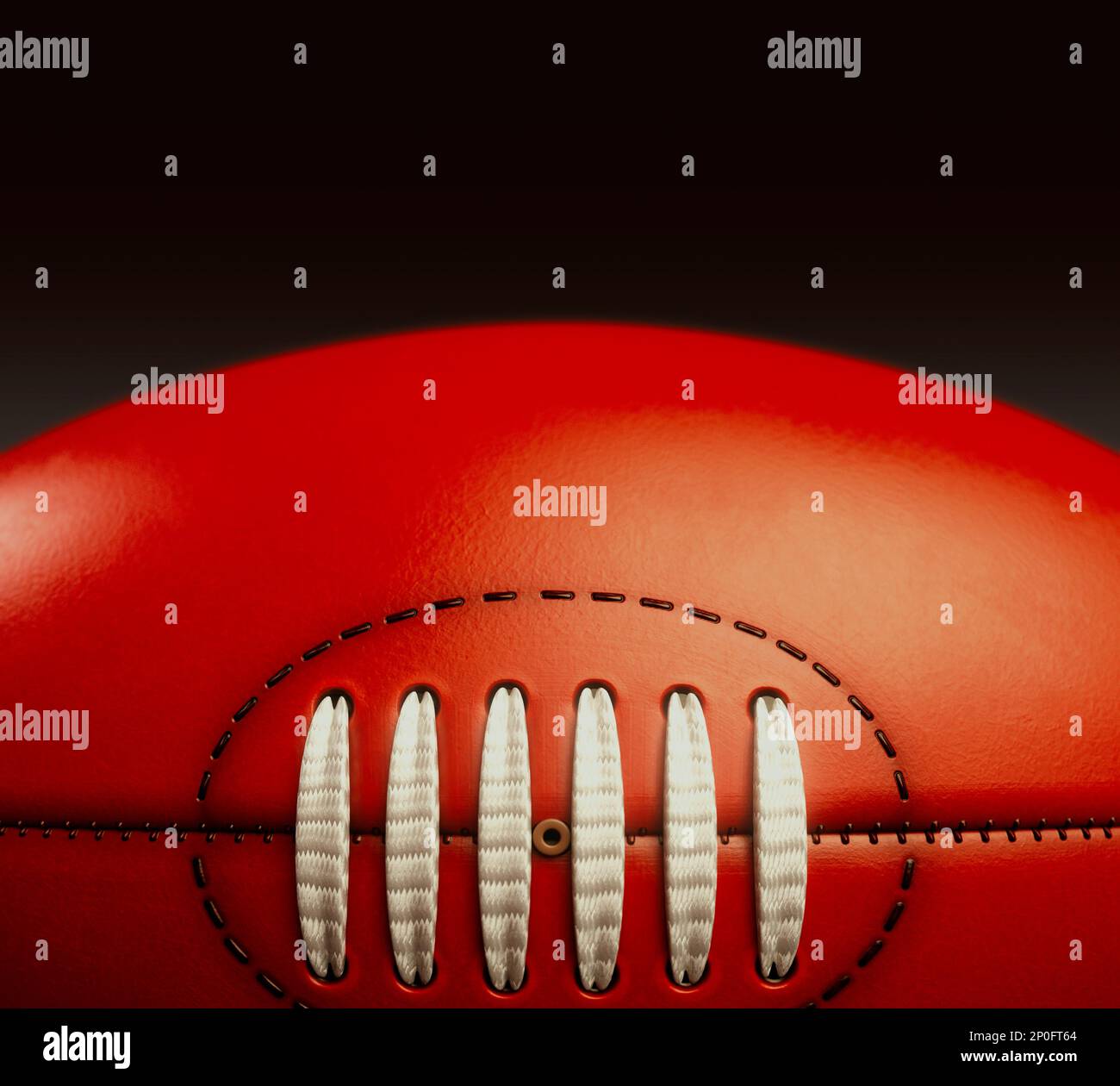 A generic unbranded aussie rules football ball on an isolated dark ...