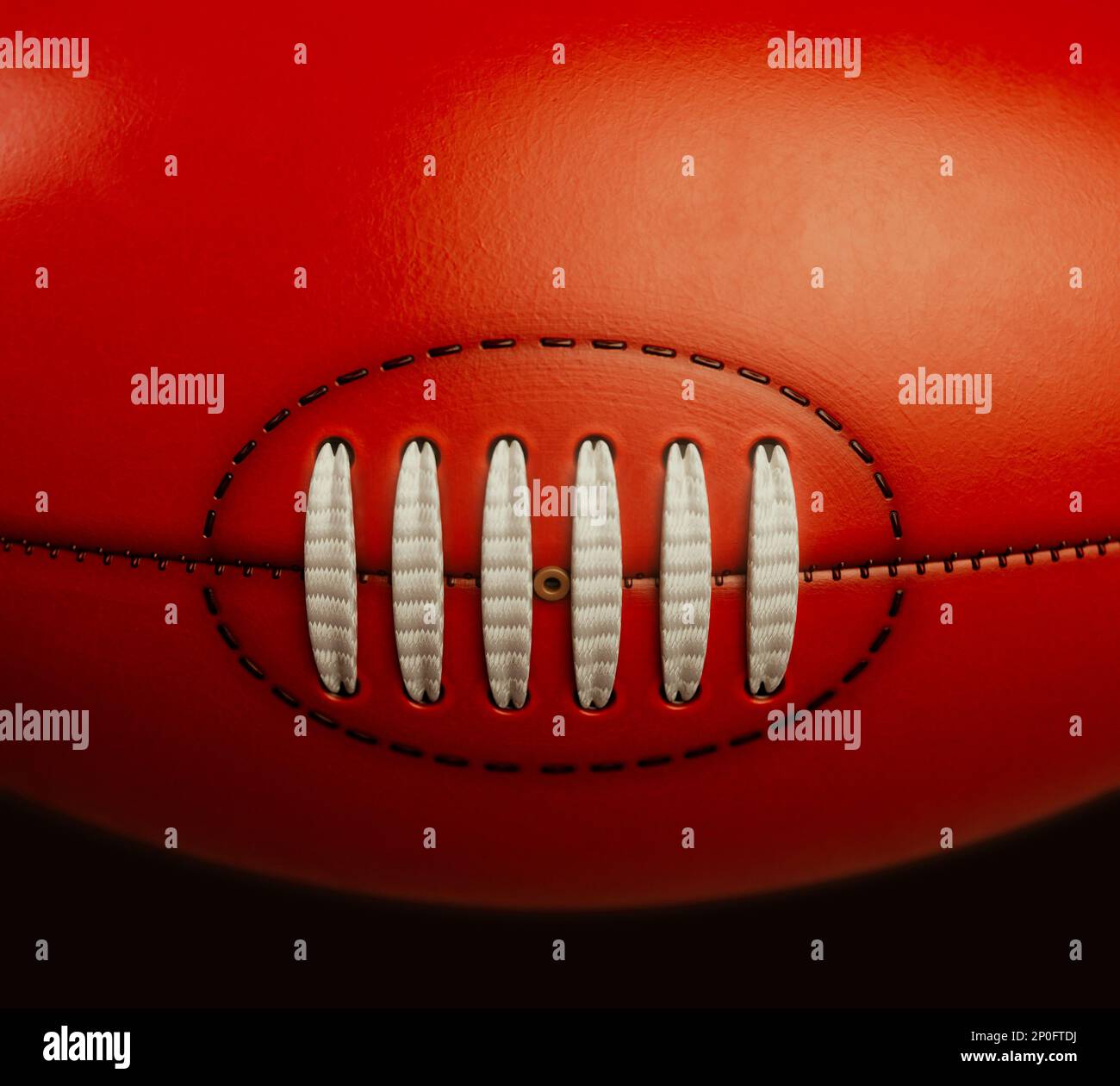 A generic unbranded aussie rules football ball on an isolated dark ...