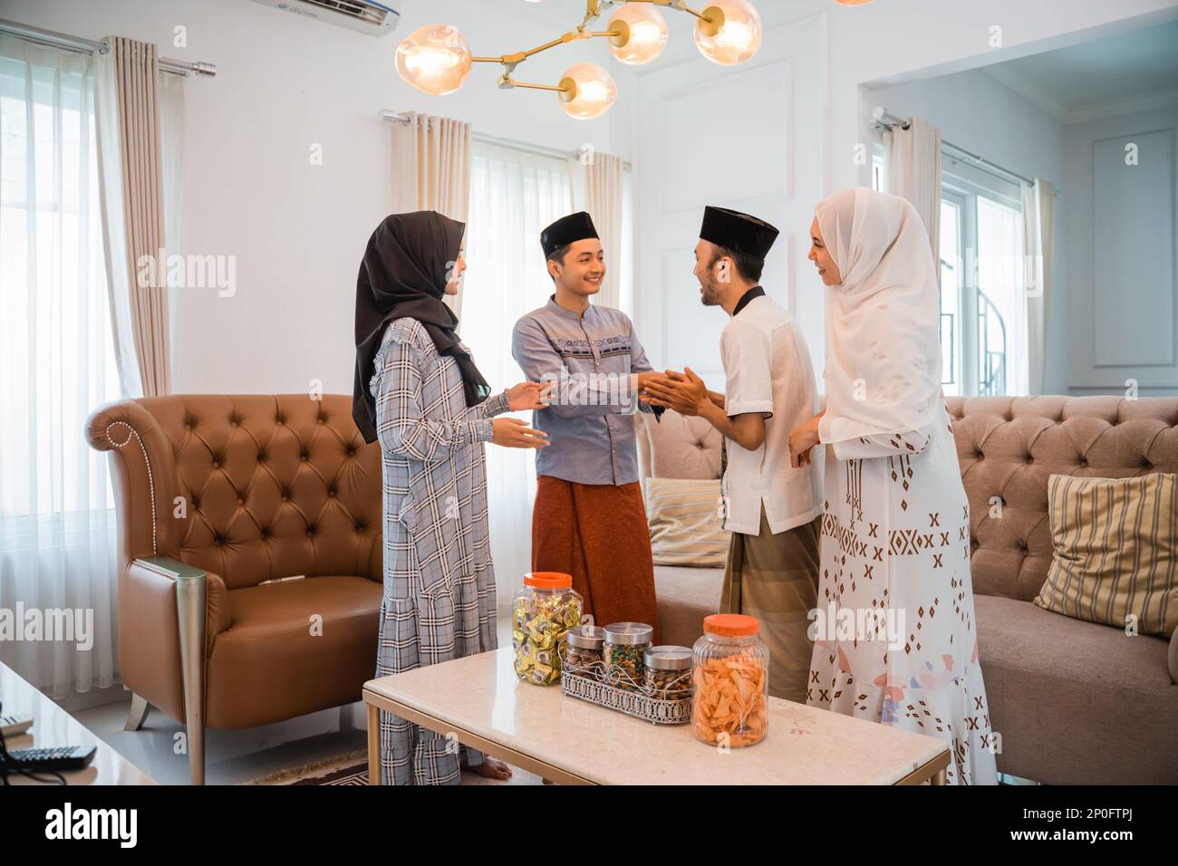Muslim couples visit neighbors to wish and shake hands Stock Photo - Alamy