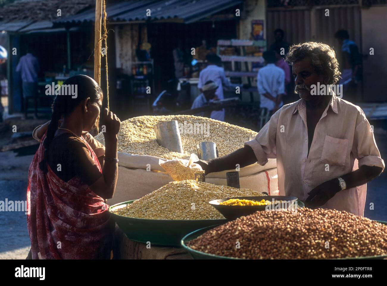 A man selling Peanuts, Roasted gram and Puffed rice at Pollachi market ...