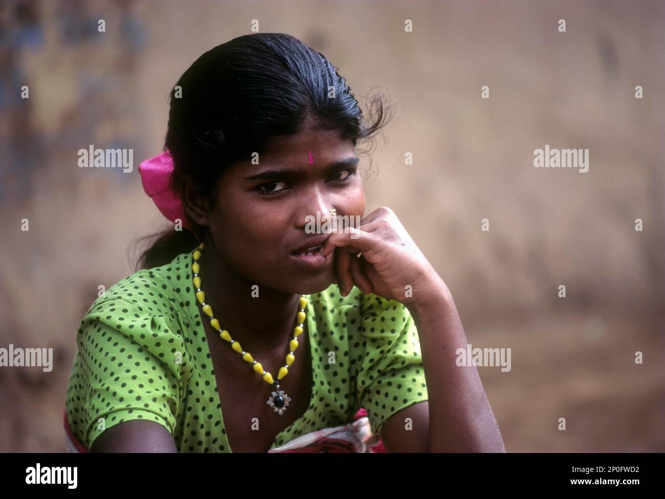 Betta Kurumba tribal girl sitting the tribal village, Mudumalai ...