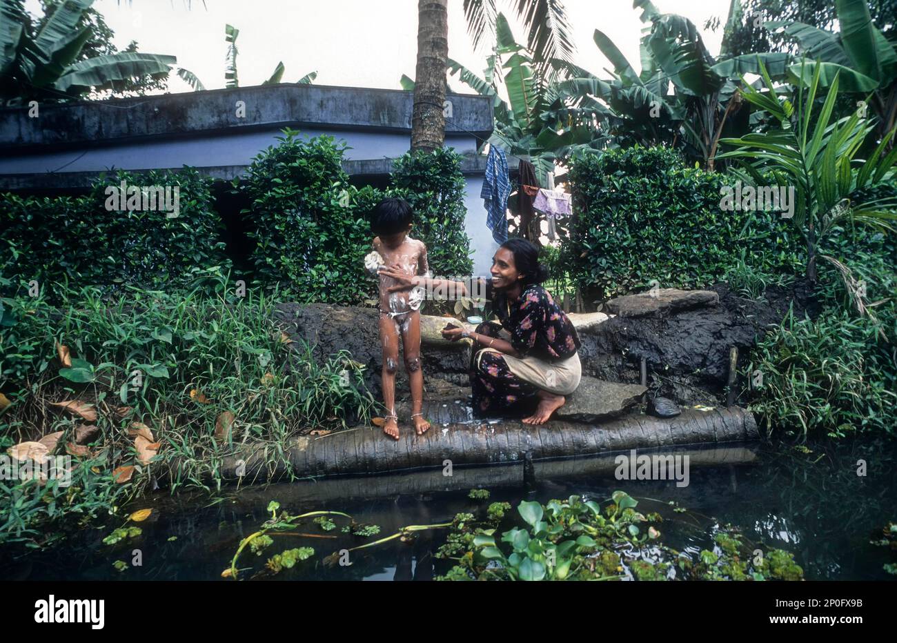 A Woman Bathing her daughter, Backwaters of kerala. Mother & child ...