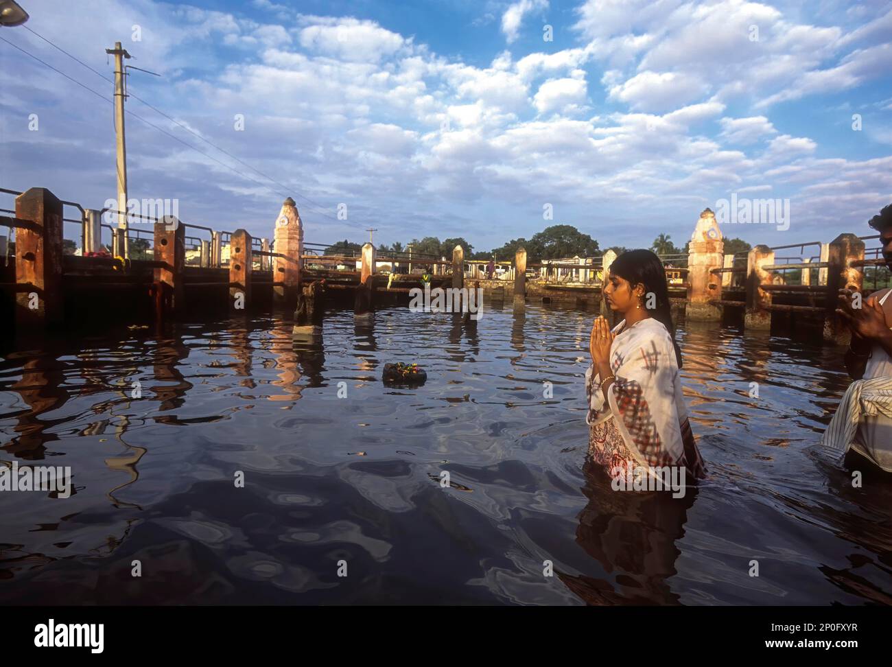 A girl worshipping Navagraha idols, nine planetary deities made of ...