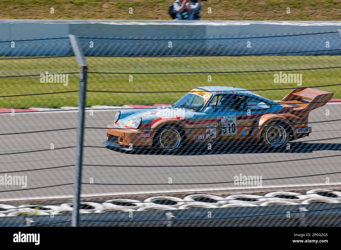 Porsche 911 RSR on race track behind safety fence, Nuerburgring race ...