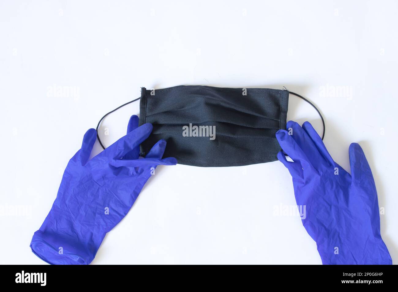 black medical homemade mask and blue gloves on a white Stock Photo - Alamy