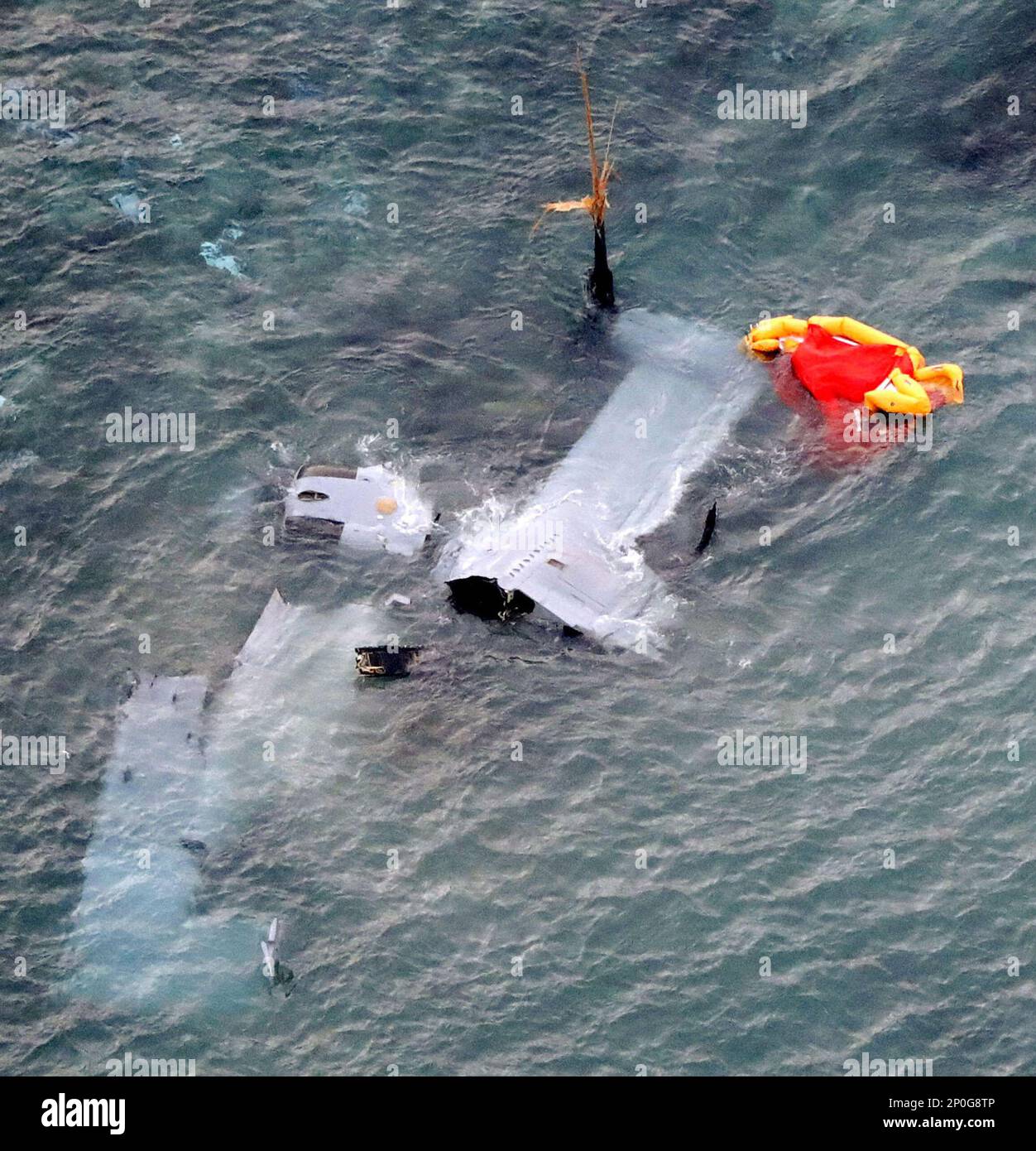 Debris of U.S. military MV-22 Osprey is seen in shallow waters off Nago ...