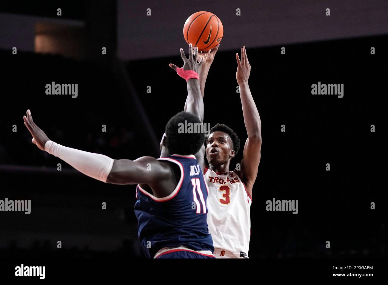 Southern California forward VIncent Iwuchukwu, right, shoots as Arizona ...