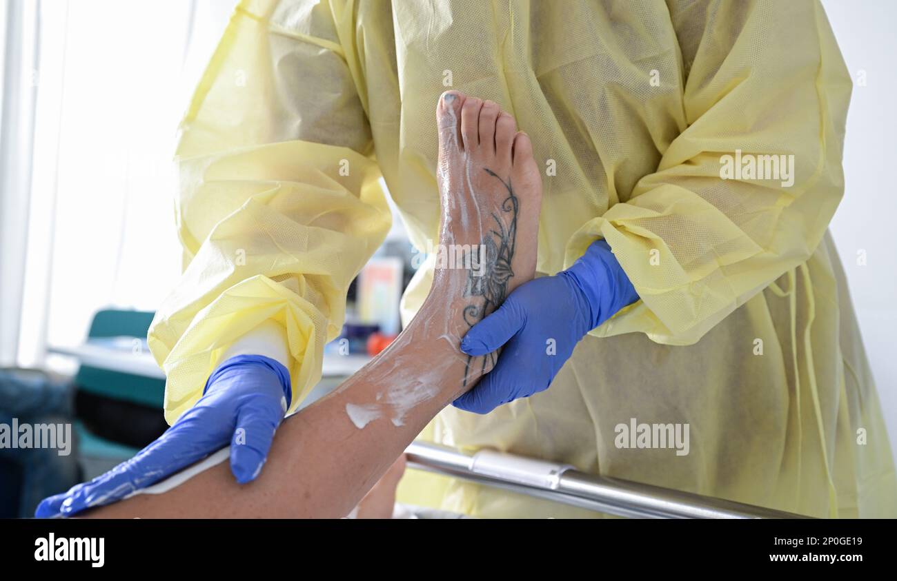 Stuttgart, Germany. 14th Feb, 2023. A nurse cares for a patient's feet ...