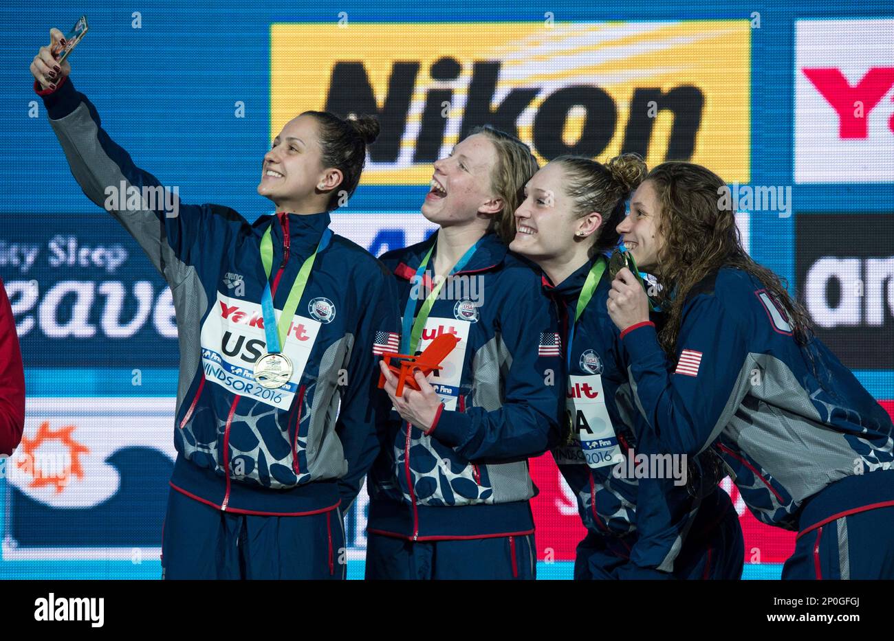 USA's Alexandra De Loof, from left, takes a photo of her and teammates ...
