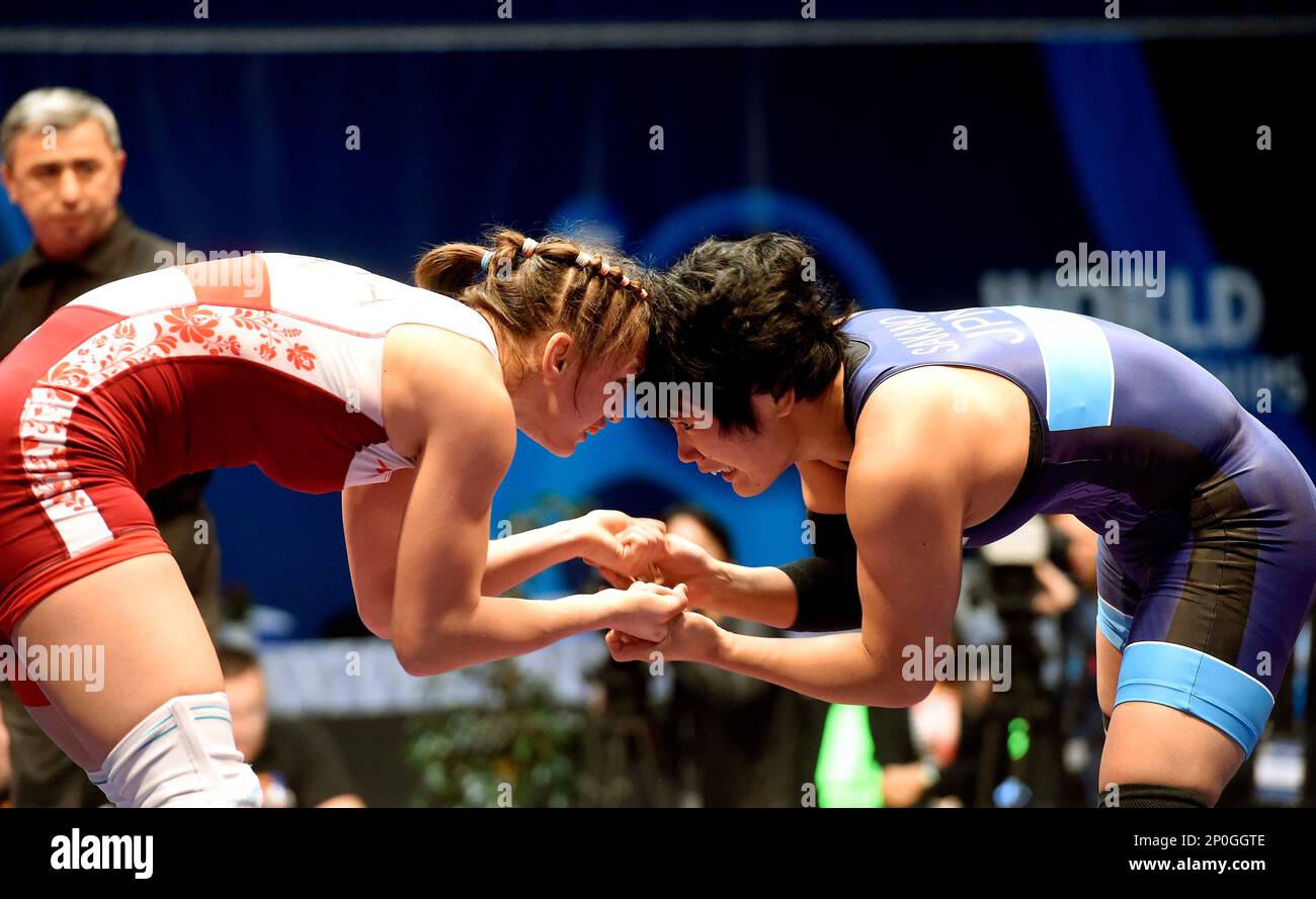 Emese Barka of Hungary, red, and Sakano Jaka of Japan fight in the ...