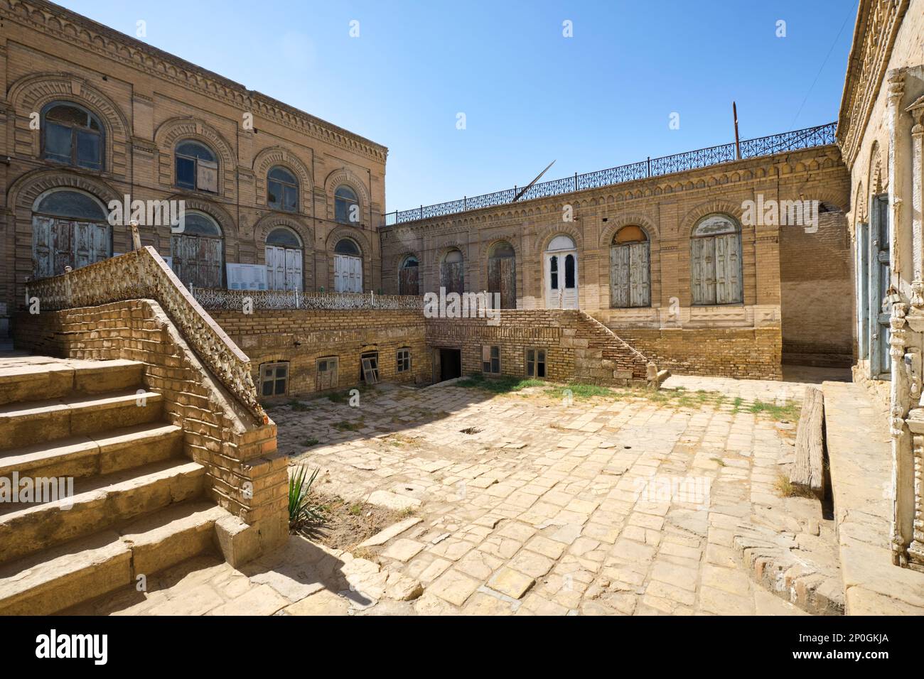 Exterior view of courtyard, brown, tan brick used for facade. At an old ...