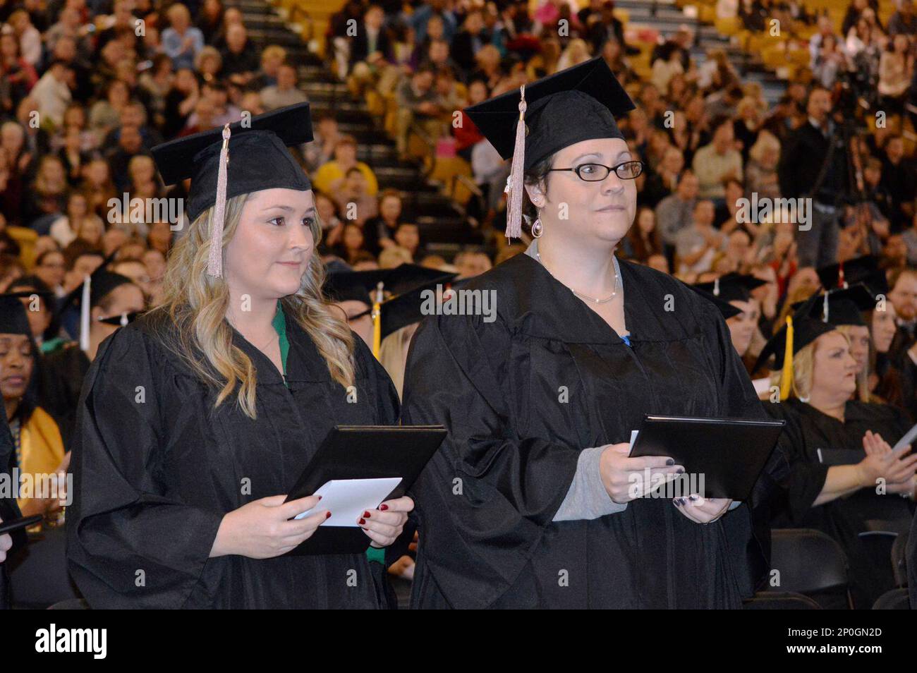 Tiffany Keil, left, and Amber Focus stand after receiving their degrees ...