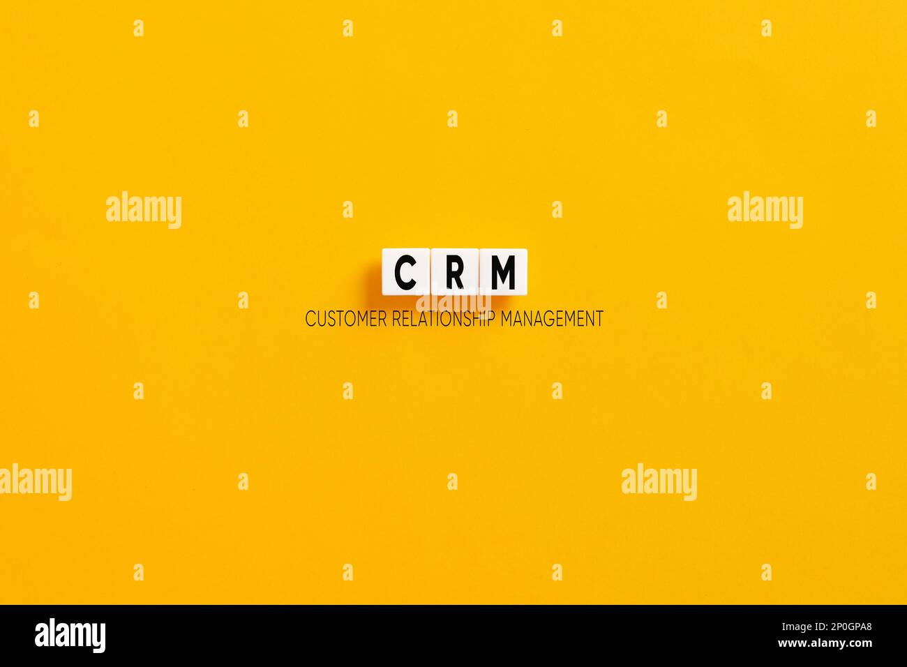 White letter blocks on yellow background with the acronym CRM customer ...