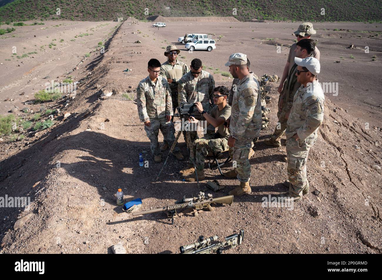 U.S. Army soldiers gather around a spotter’s scope during an East ...