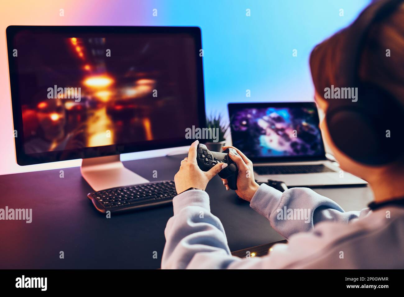 Teenager girl playing video game at home. Gamer holding gamepads ...