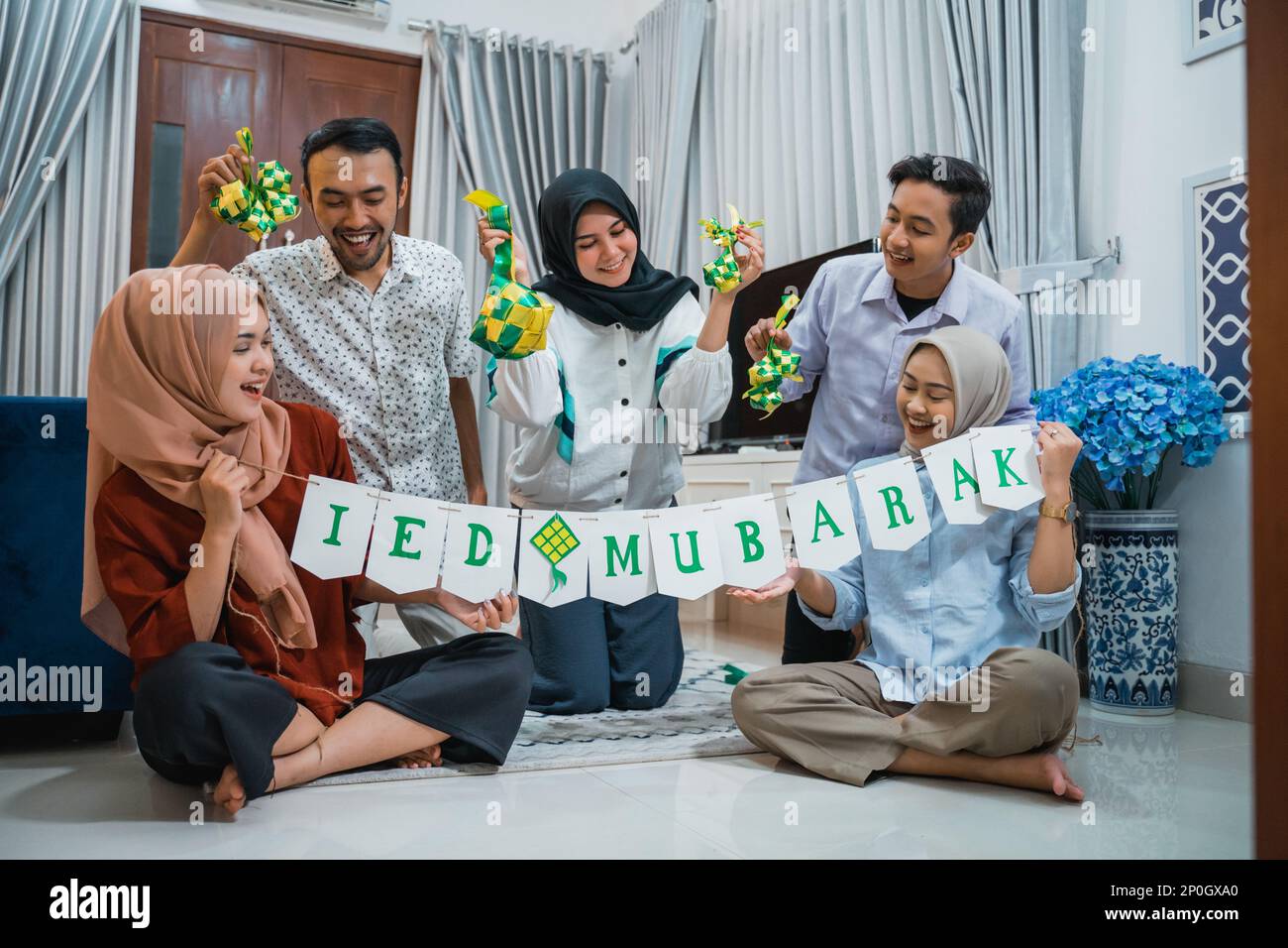Asian Muslim friends show flag chains and decorations for Eid Stock ...