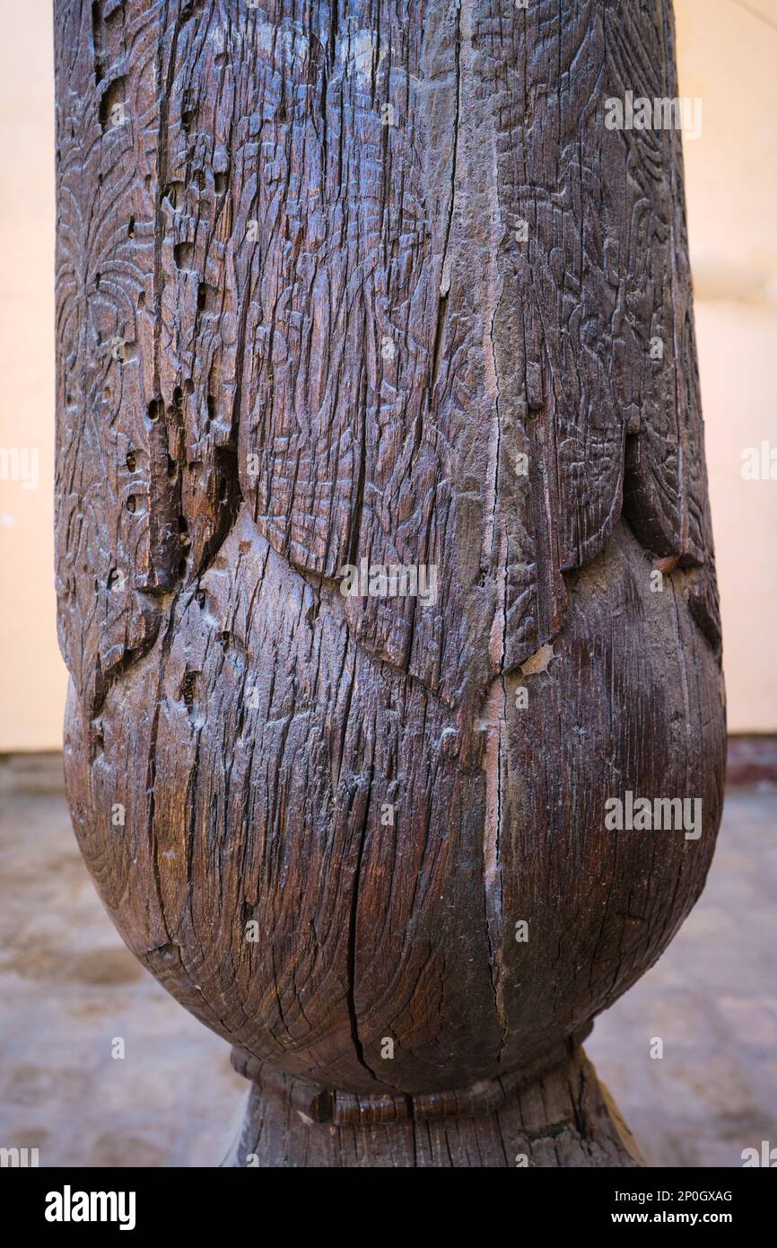 Close up, detail of the base of a carved wood column on a porch. At an ...