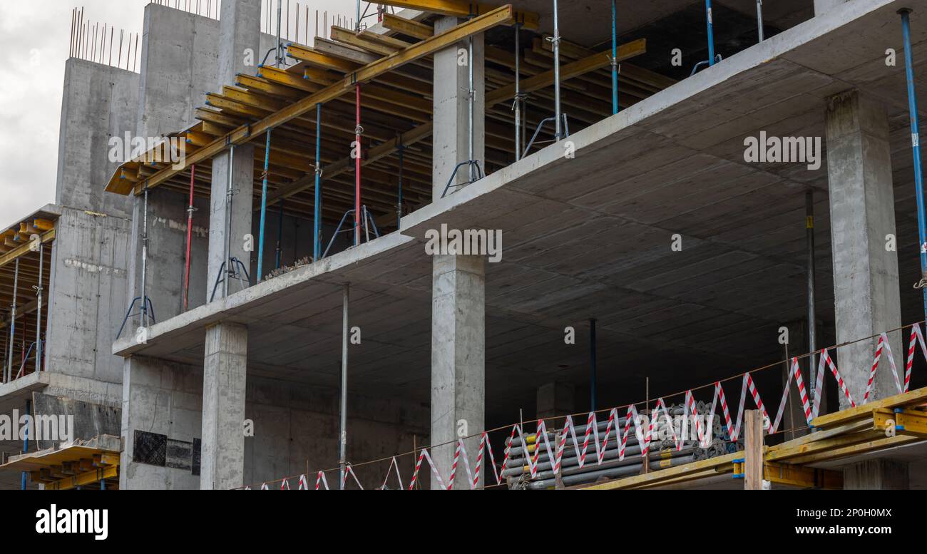 Multi-level commercial high-rise building construction with blue sky ...