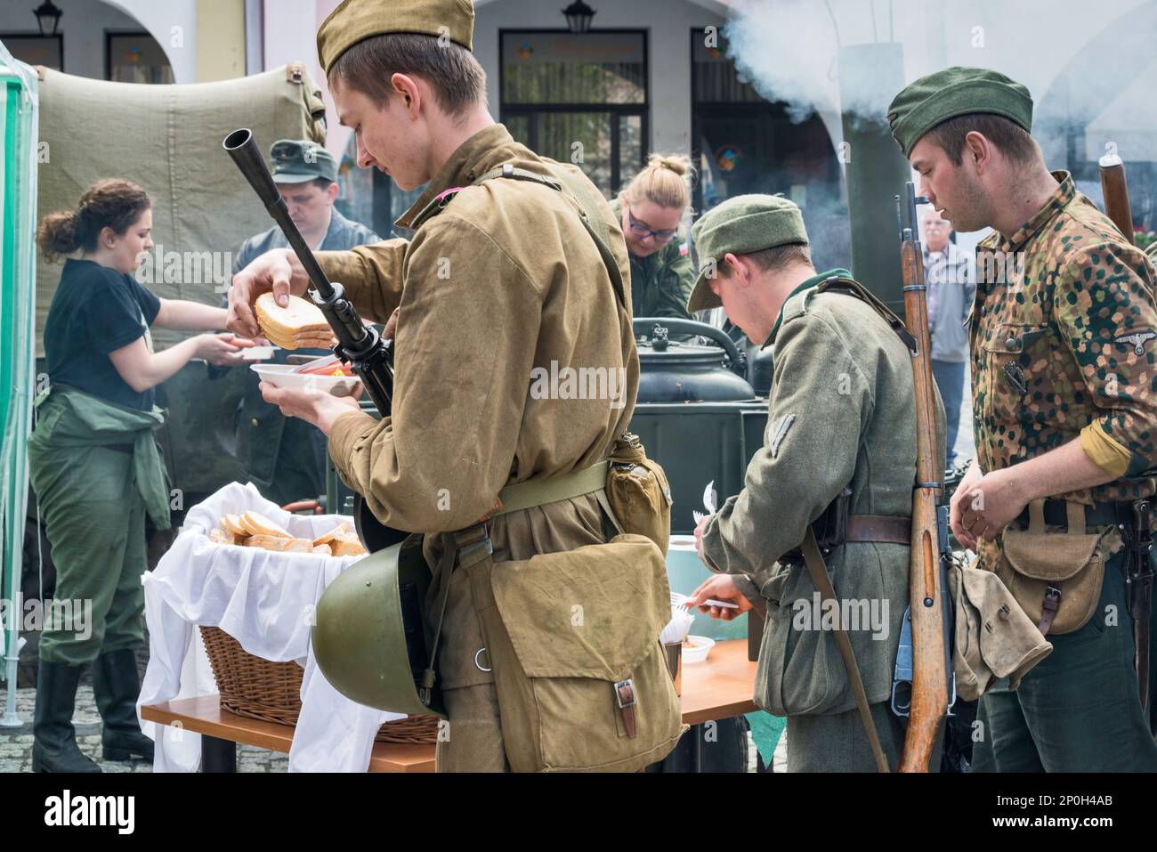 Reenactors at field kitchen, before reenactment of fictitious WW2 ...