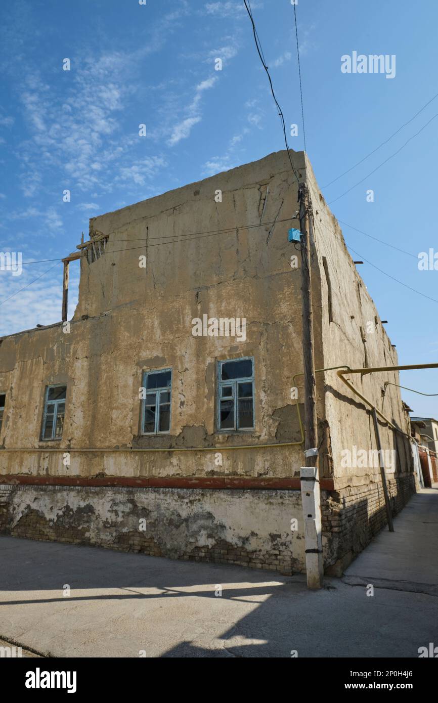 Unassuming, plain exterior of a house, now in ruin. At an old, historic ...
