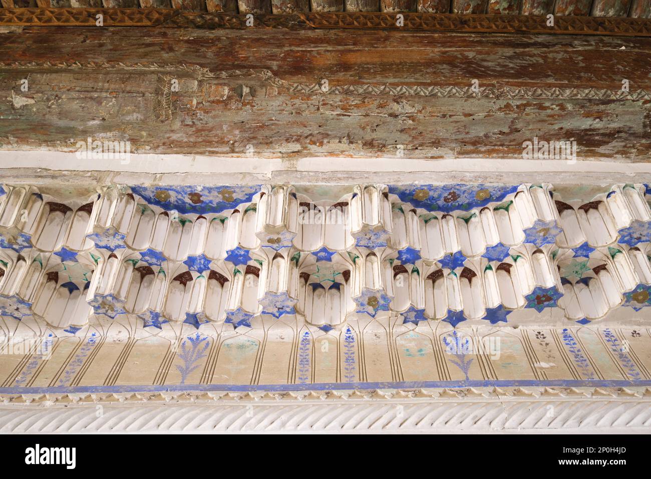 Close up, detail of the fine stalactite, muqarnas painted plaster work ...