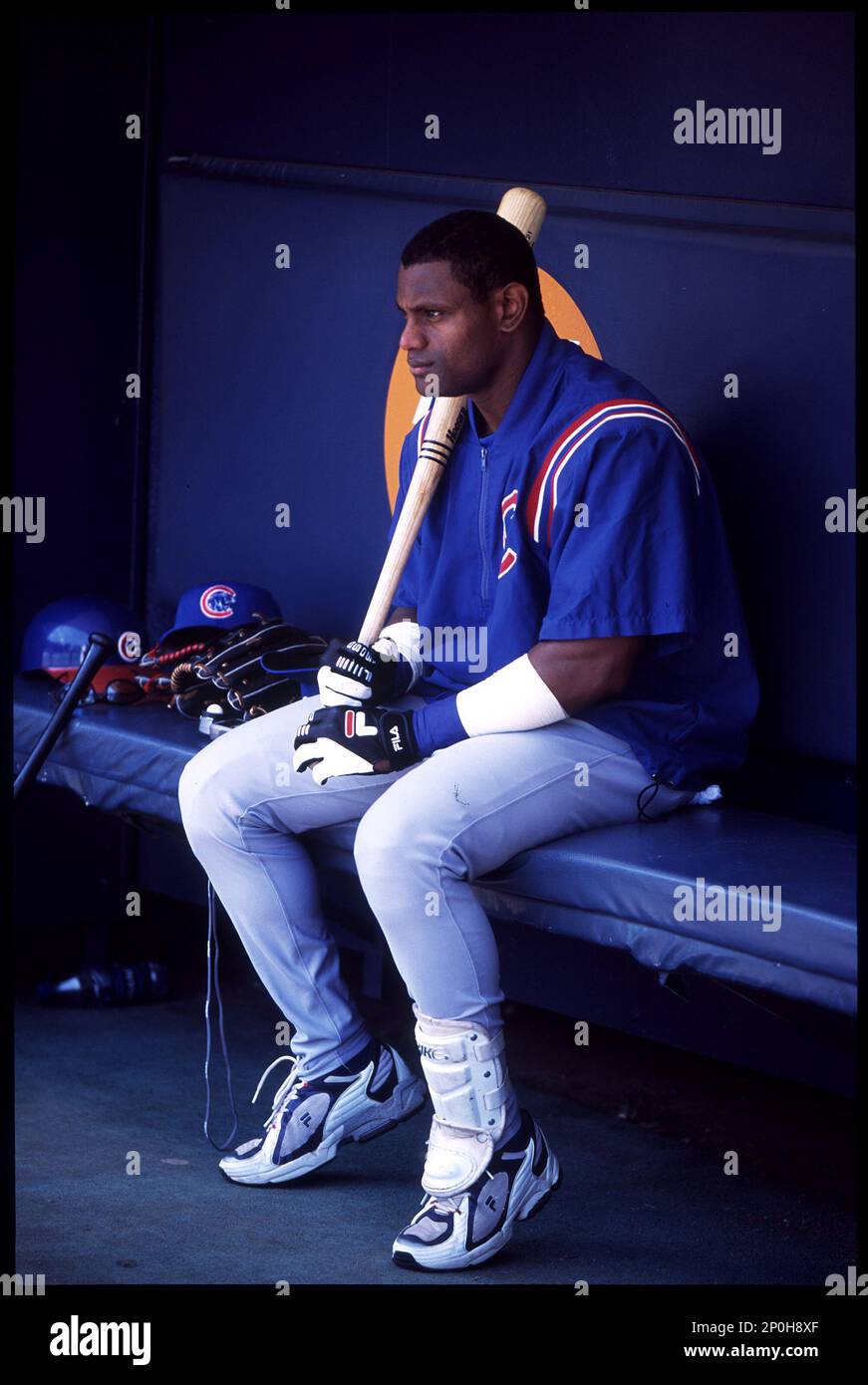 2002: Sammy Sosa of the Chicago Cubs relaxes in the dugout before a ...