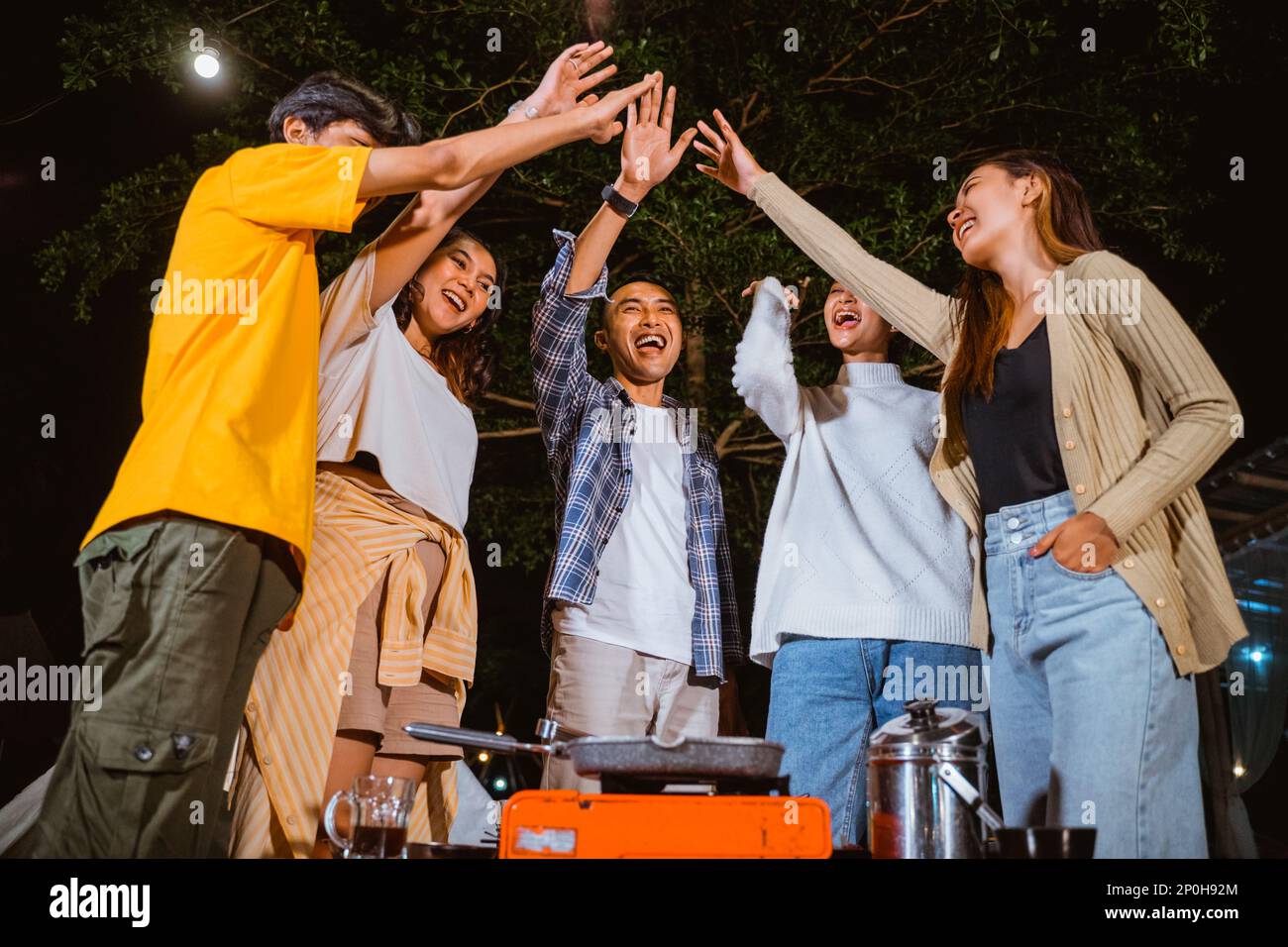 a group of people doing the high fived happily Stock Photo - Alamy