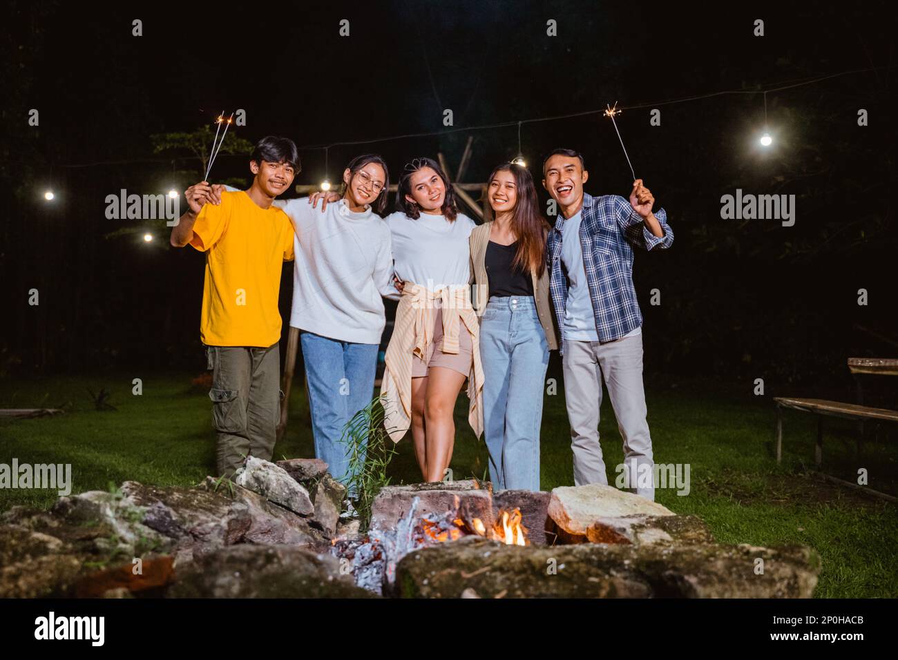 Group of people standing around a fire hi-res stock photography and ...