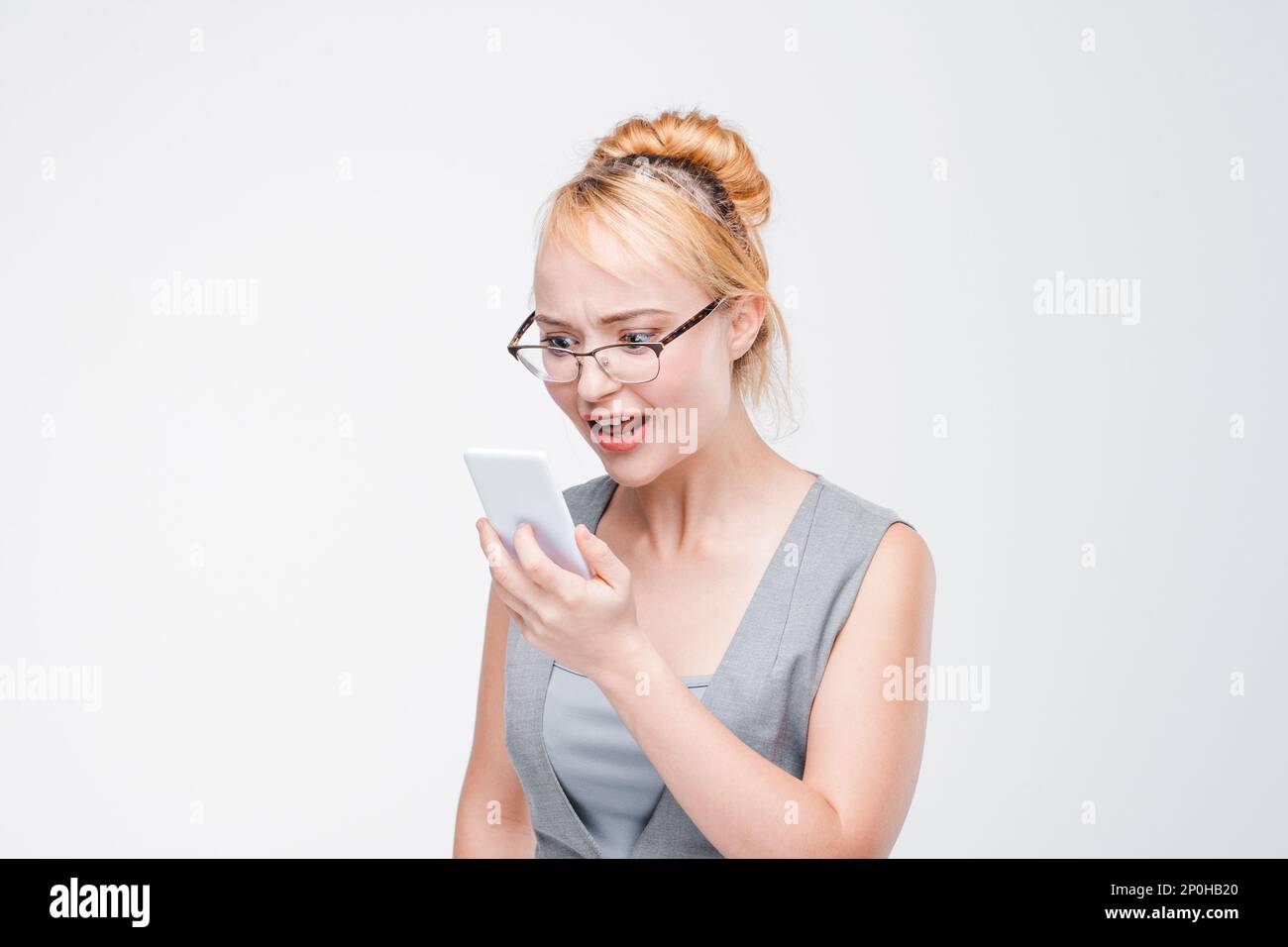 Irritated girl with phone disgruntled and peeved Stock Photo - Alamy