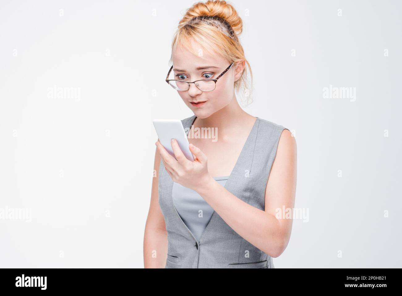 Young woman with phone angry, peeved and irritated Stock Photo - Alamy