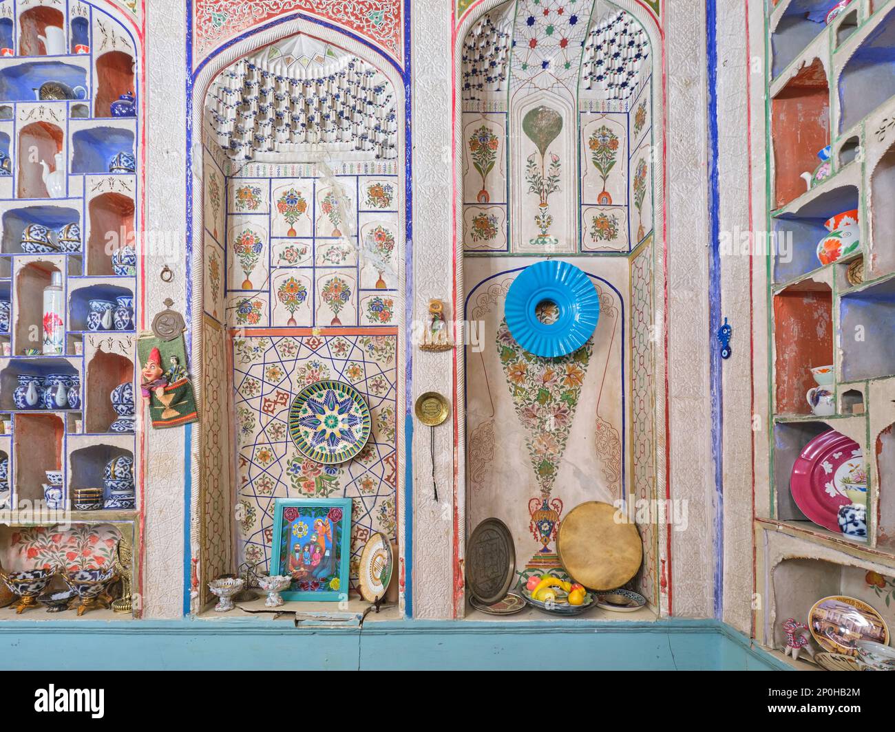Detail of family dishes, china, art, items in the cutout, casework. A ...