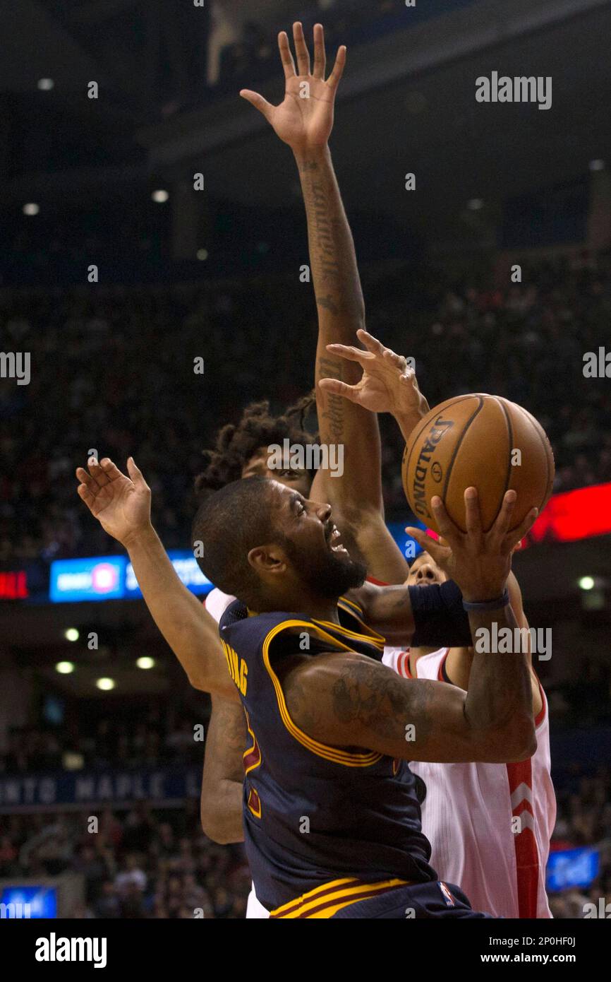 Cleveland Cavaliers guard Kyrie Irving, center, shoots on Toronto ...