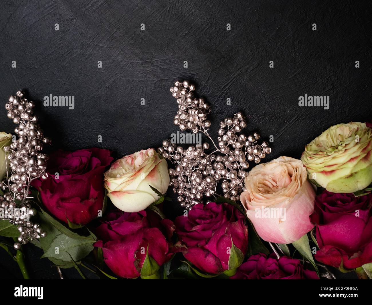 red pink roses silver decor dark floral background Stock Photo - Alamy