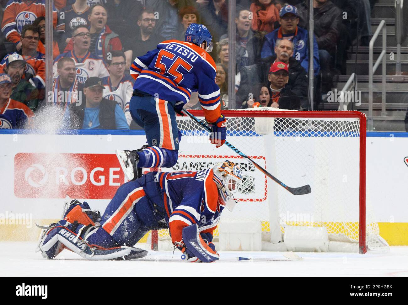 Edmonton Oilers' Mark Letestu (55) jumps over goalie Jonas Gustavsson ...