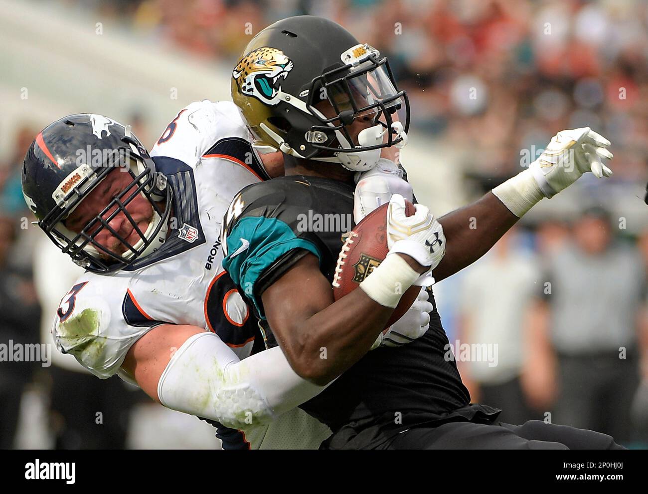 Jacksonville Jaguars running back T.J. Yeldon, right, is stopped by ...