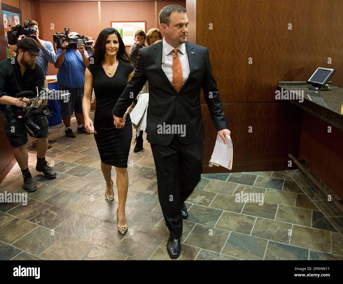 Tom Herman and his wife Michelle make their way into a preconference in ...