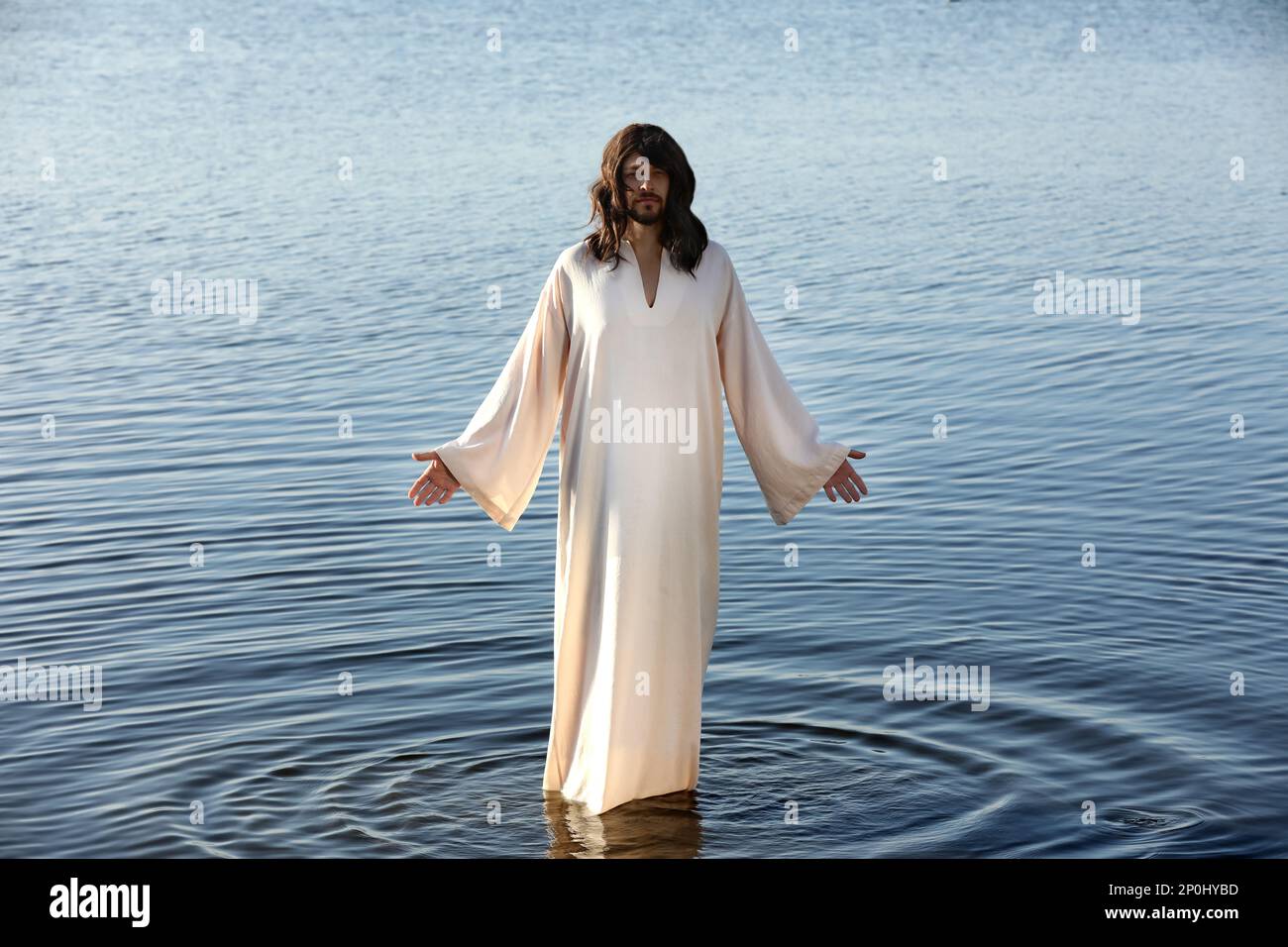Jesus Christ in water lit by morning sun Stock Photo - Alamy