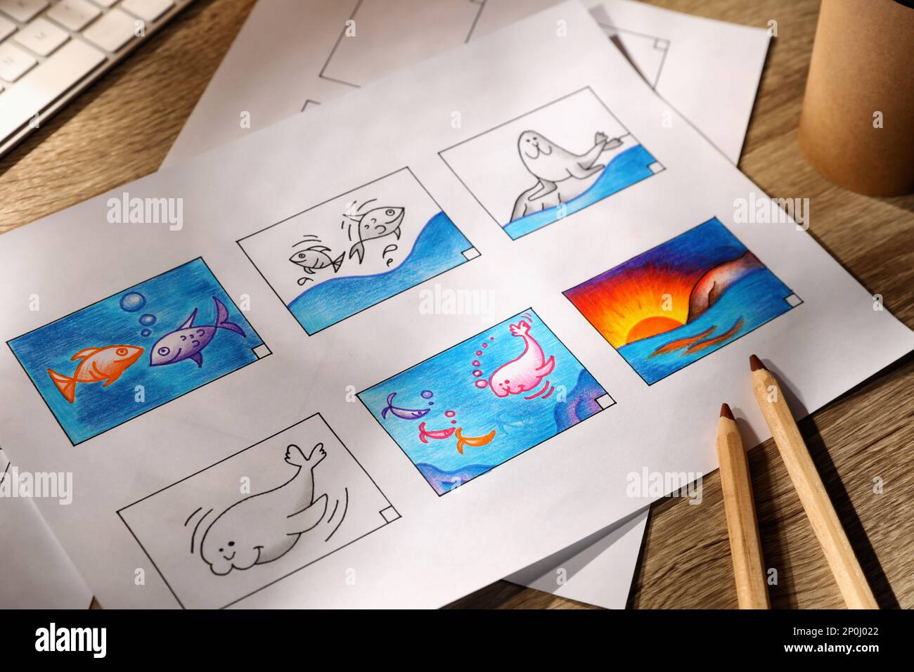 Storyboard with cartoon sketches at workplace. Pre-production process ...