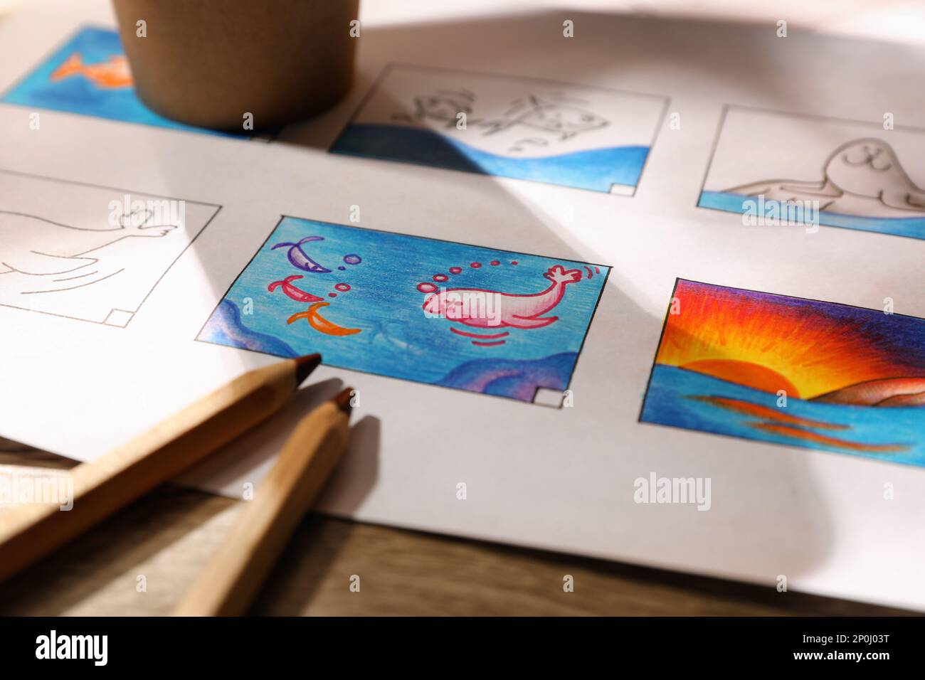 Storyboard with cartoon sketches at workplace, closeup. Pre-production ...