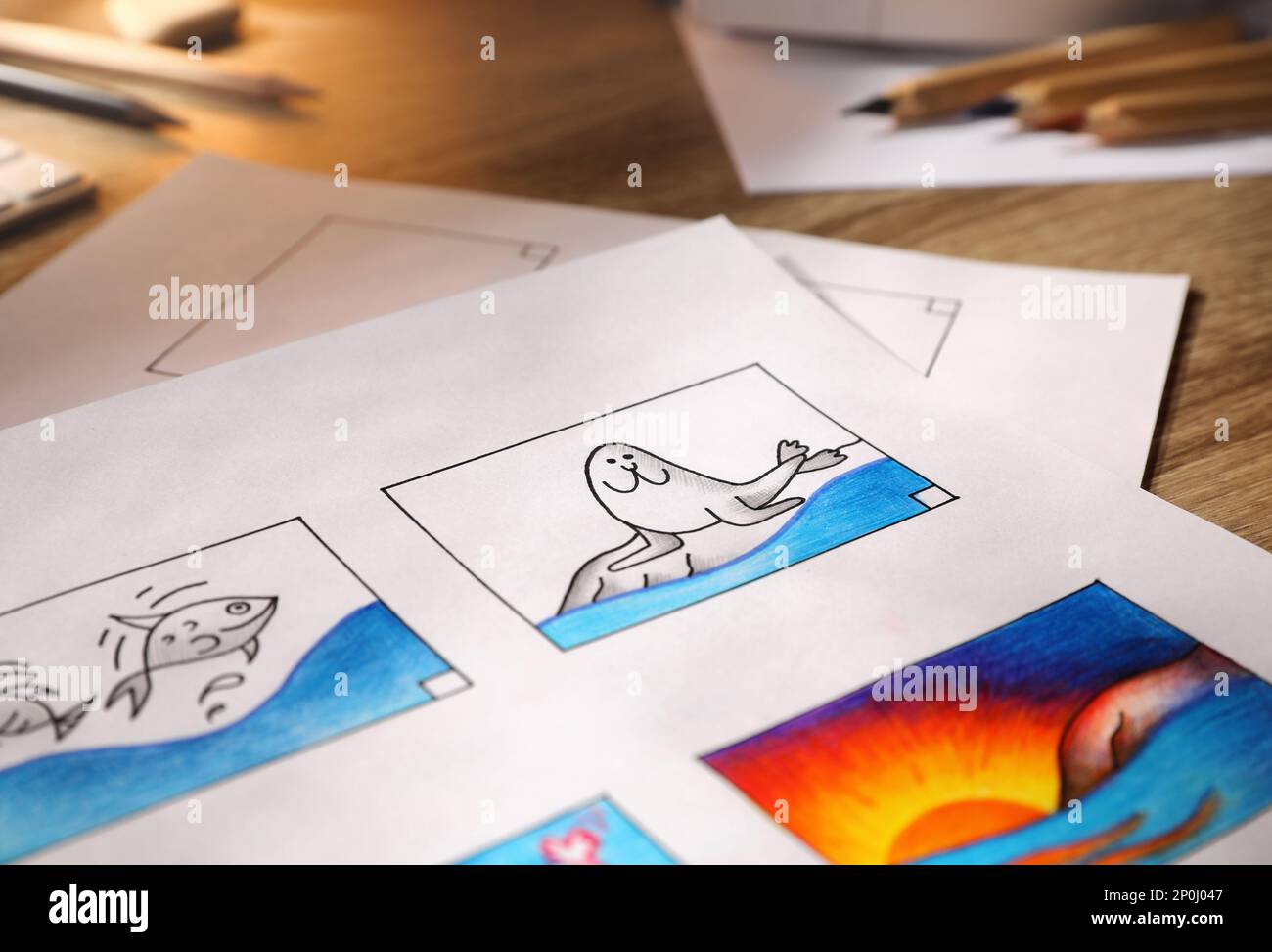 Storyboard with cartoon sketches at workplace, closeup. Pre-production ...
